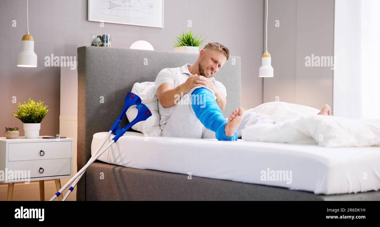 Man With Broken Leg Fracture Injury And Cast Using Crutches Stock Photo ...