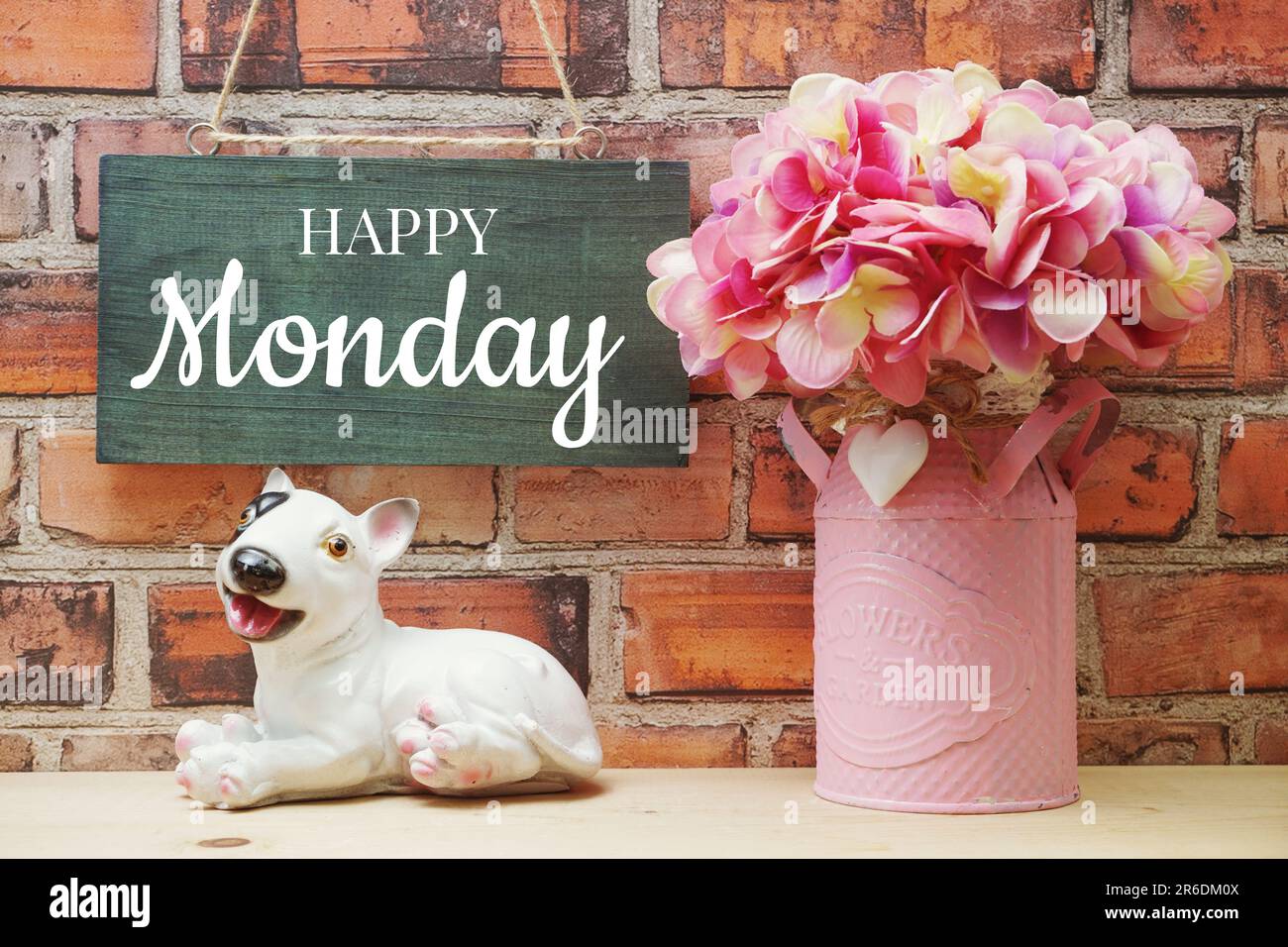 Happy Monday text message on wooden hanging on old brick wall ...