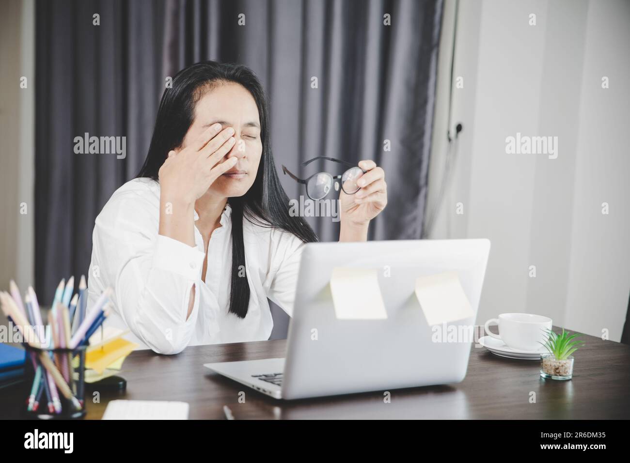 Young business woman person sleepy and has frustration eye problems ...