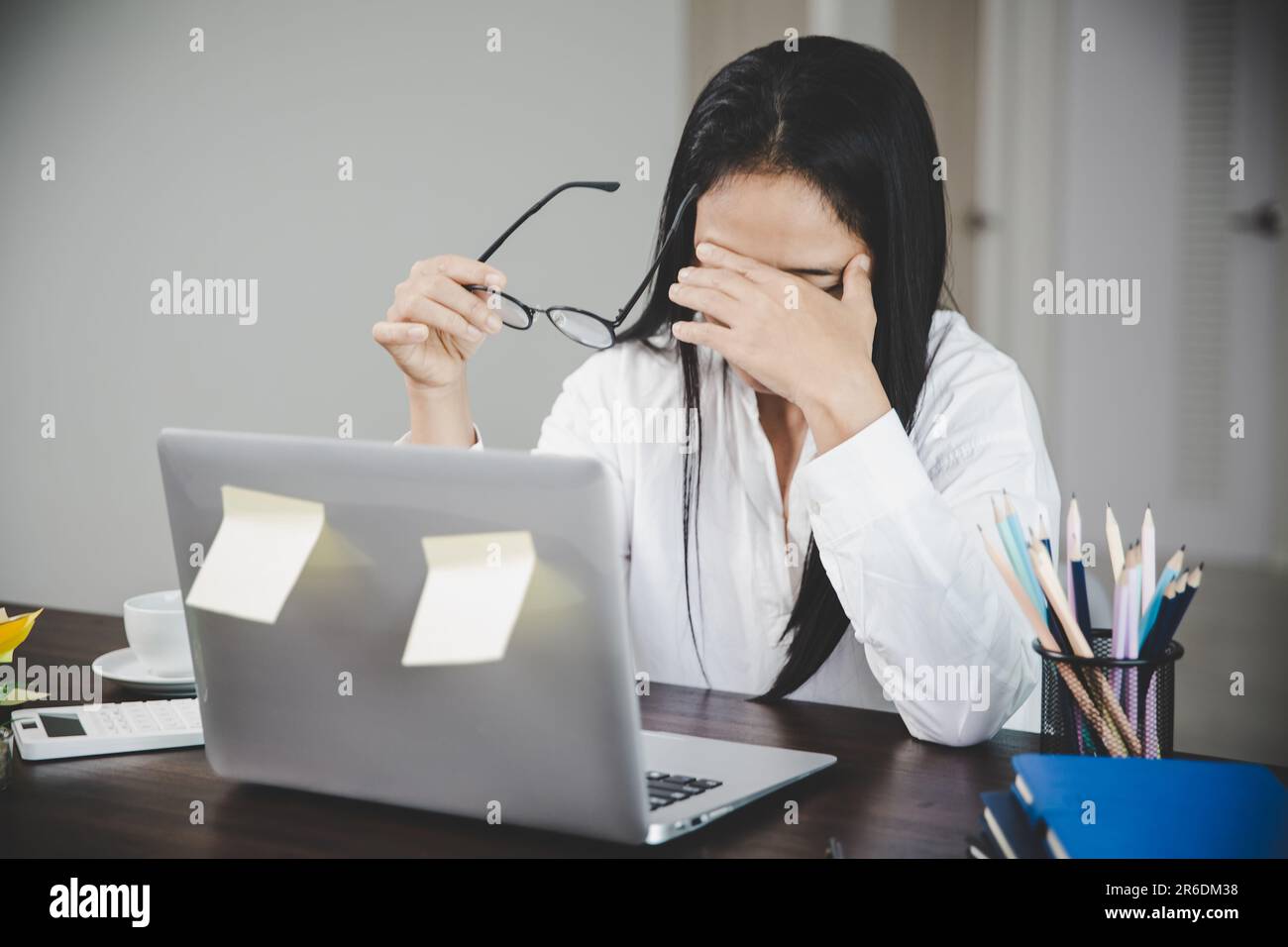 Young business woman person sleepy and has frustration eye problems ...