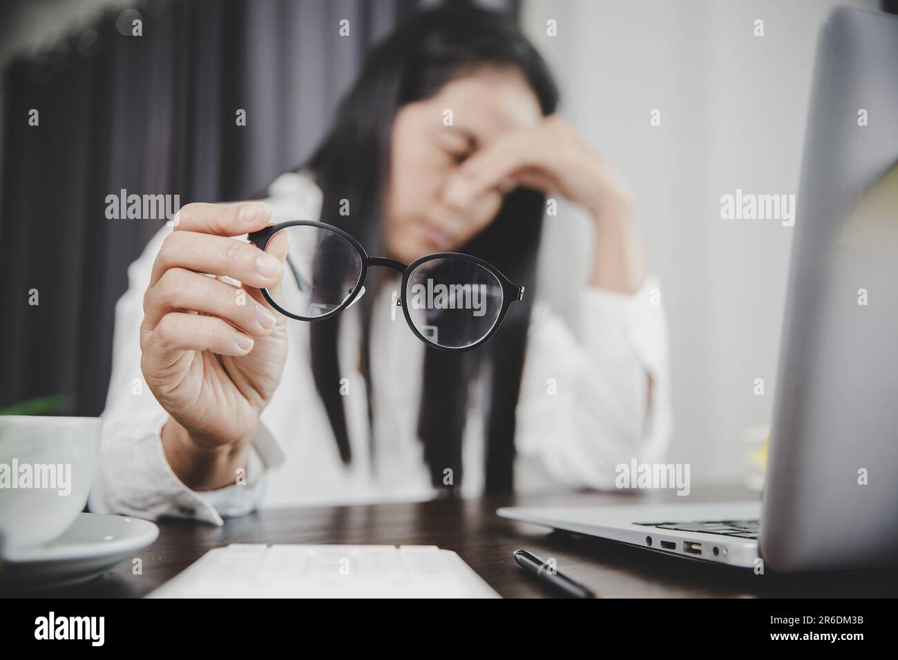 Young business woman person sleepy and has frustration eye problems ...