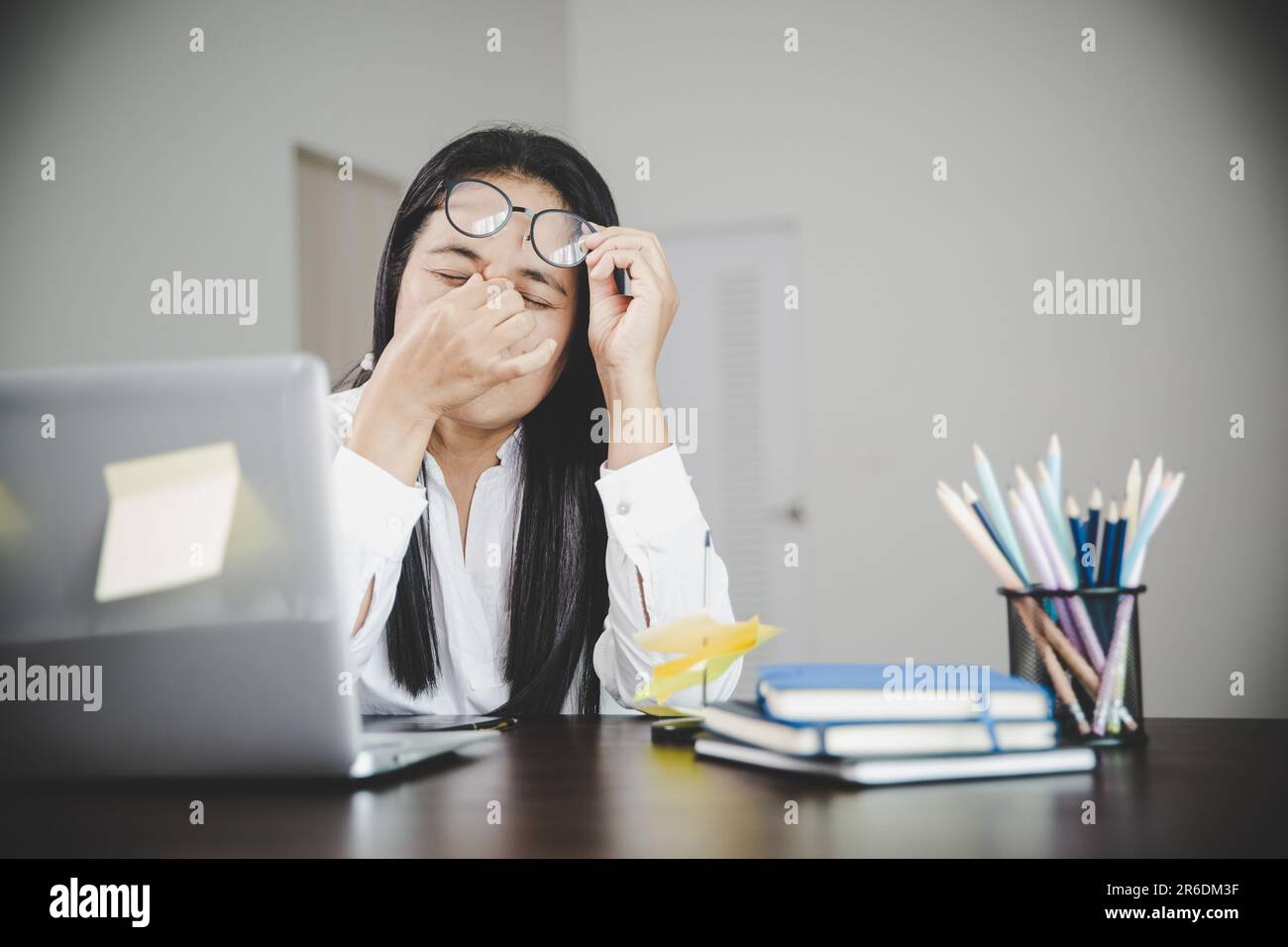 Young business woman person sleepy and has frustration eye problems ...