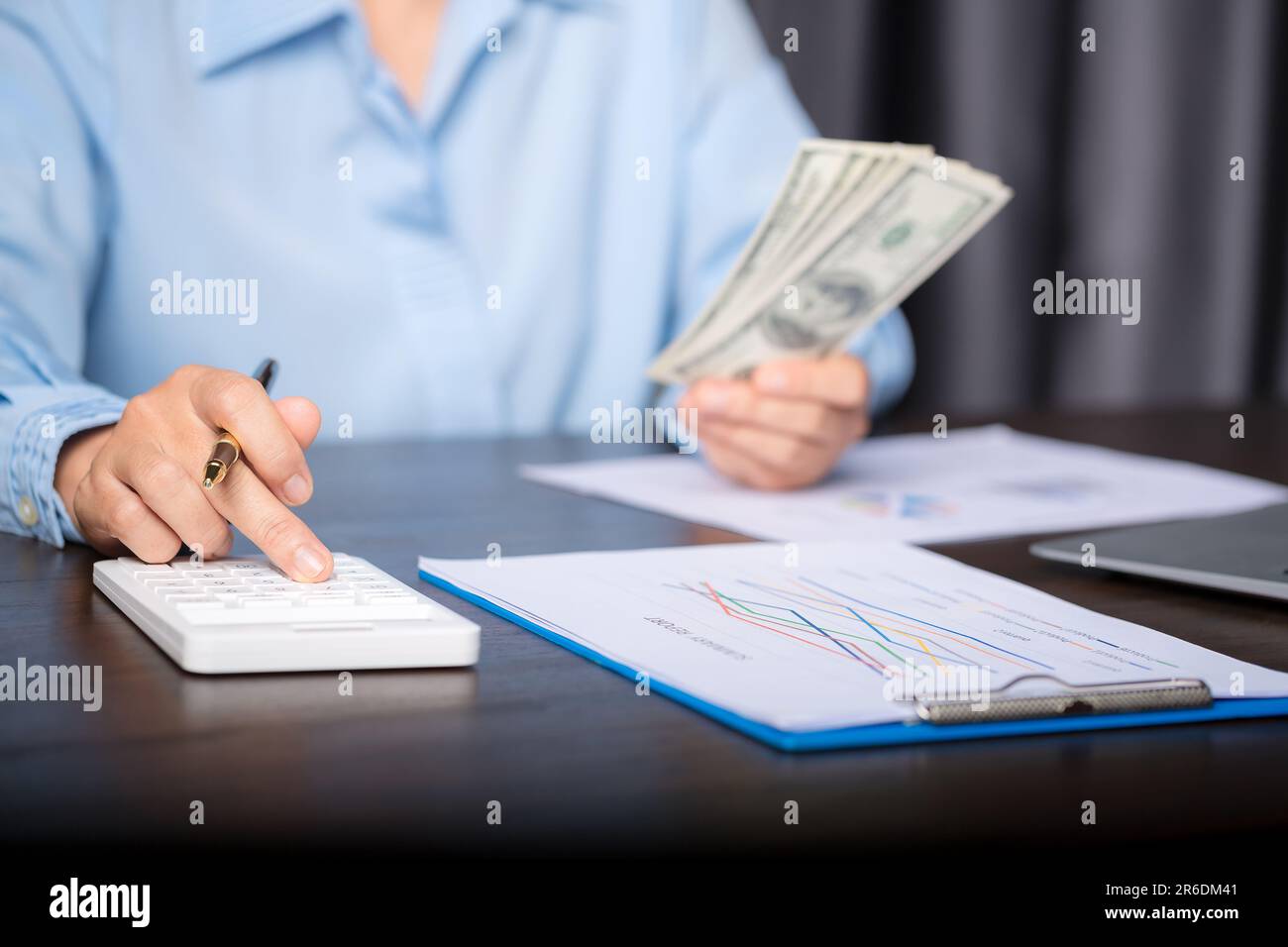 Close up young business woman using counting cash money one hundred ...