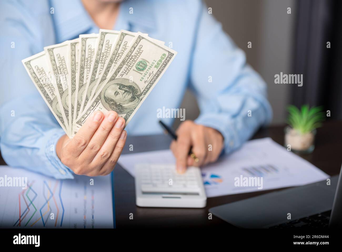 Close up young business woman using counting cash money one hundred ...