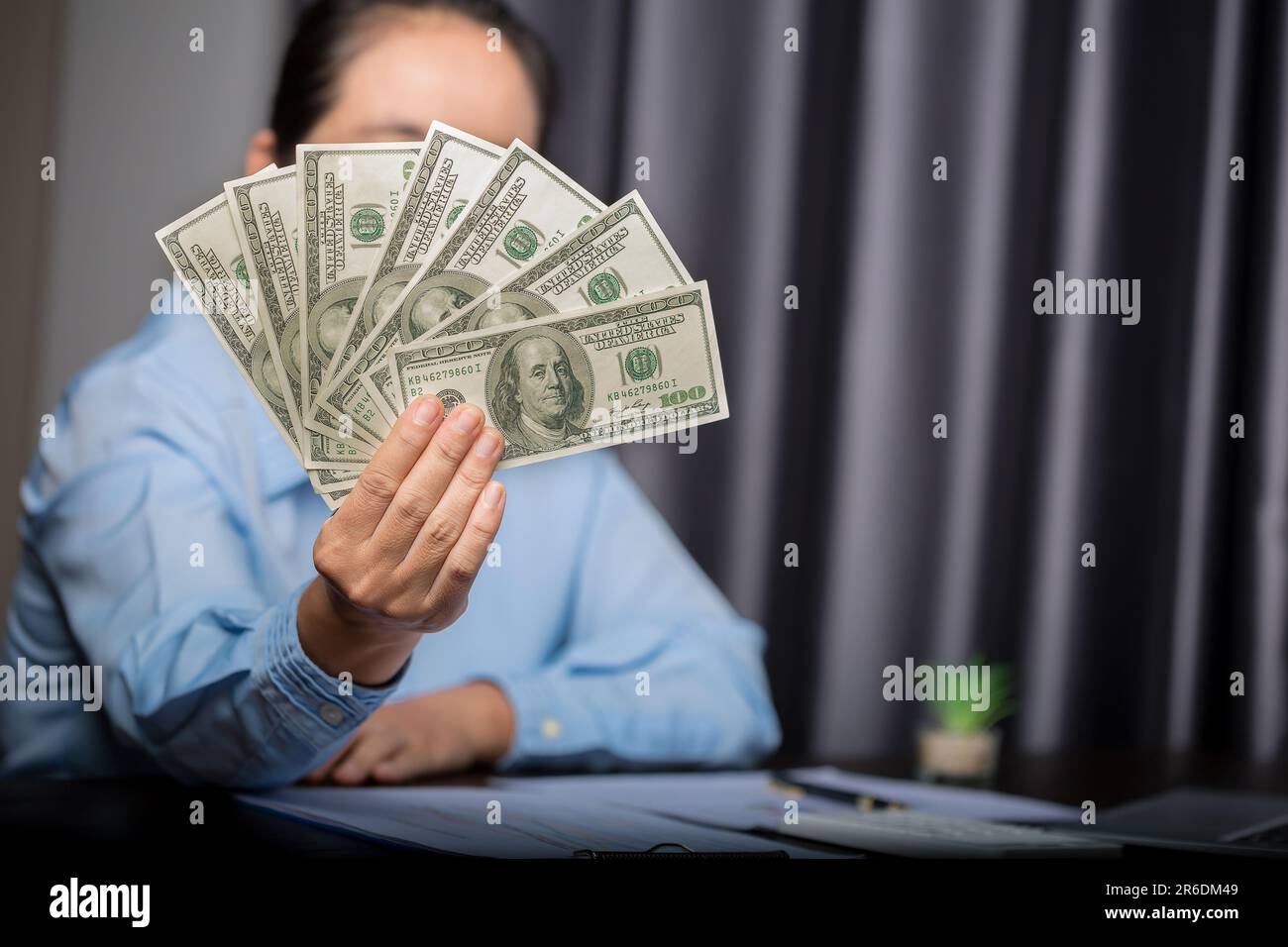 Close up young business woman using counting cash money one hundred ...