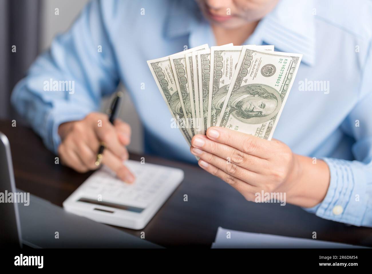 Close up young business woman using counting cash money one hundred ...