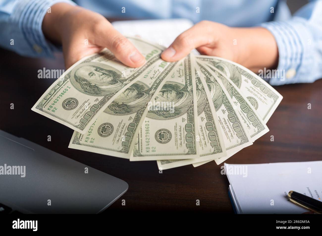 Close up young business woman using counting cash money one hundred ...