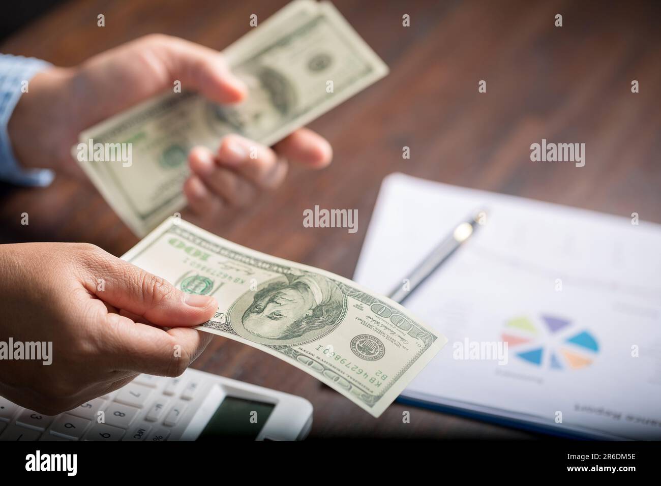 business woman hand giving one hundred dollar bills, close-up of a hand ...