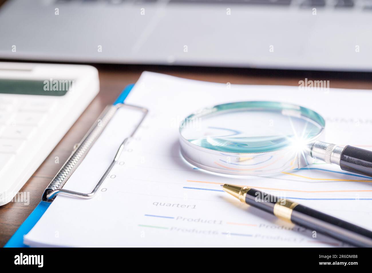 magnifying glass with business document financial paper chart statistic ...