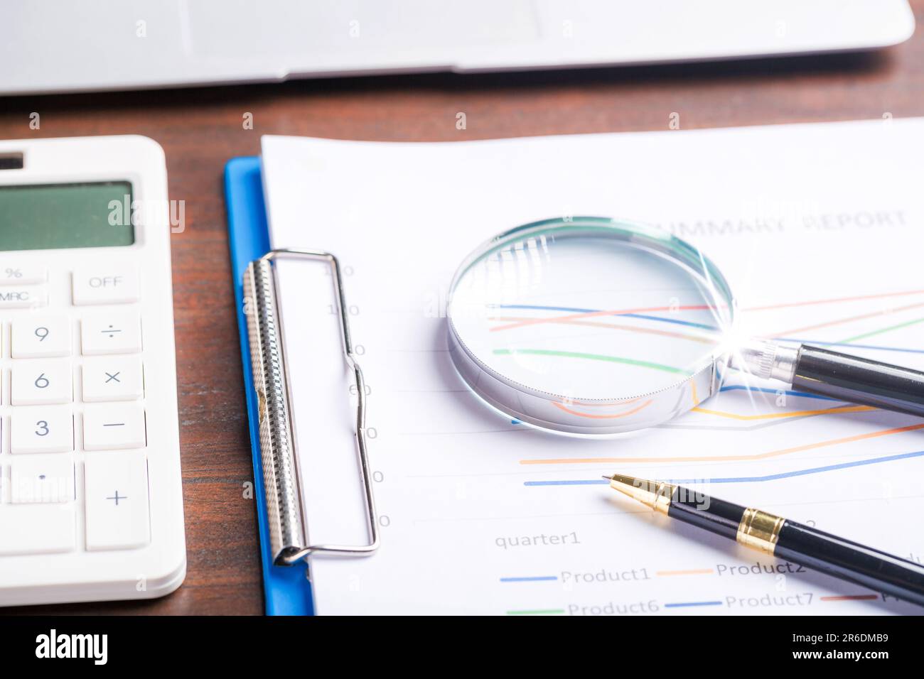 magnifying glass with business document financial paper chart statistic ...