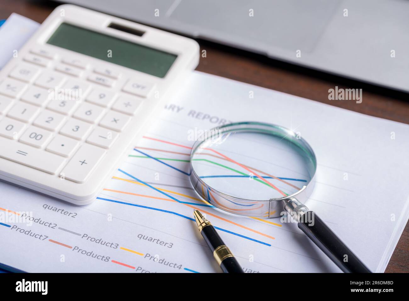 magnifying glass with business document financial paper chart statistic ...