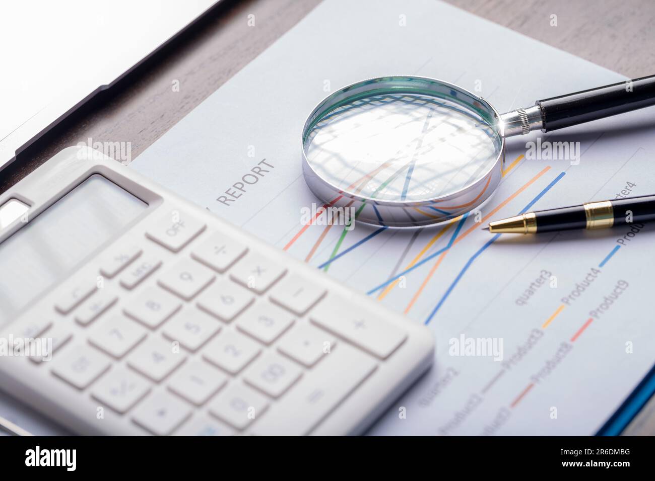 magnifying glass with business document financial paper chart statistic ...