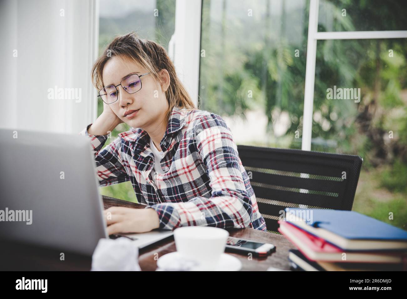 woman sitting down, his face unsettled. At the computer desk she has ...