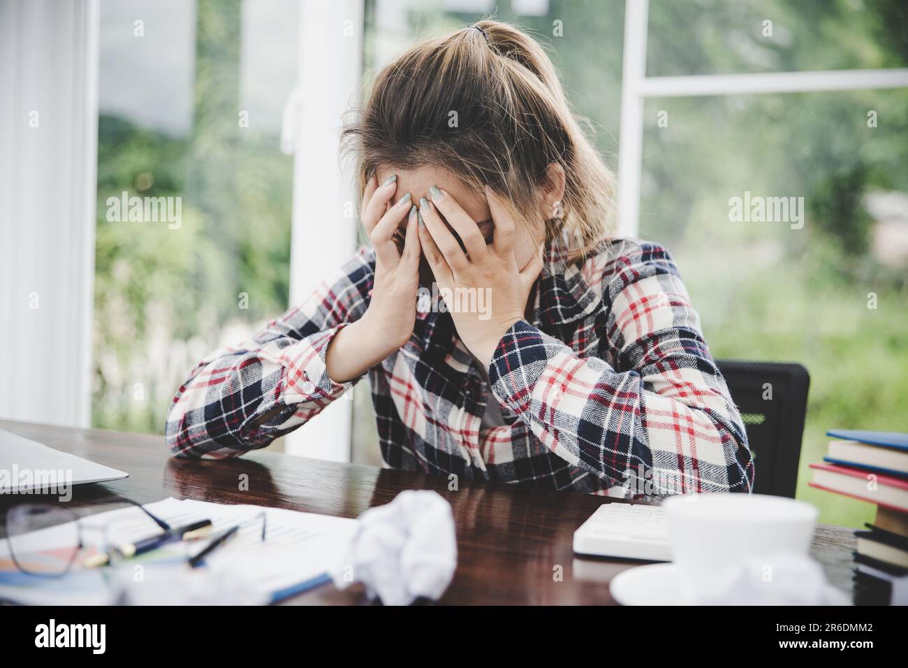 woman sitting down, his face unsettled. At the computer desk she has ...