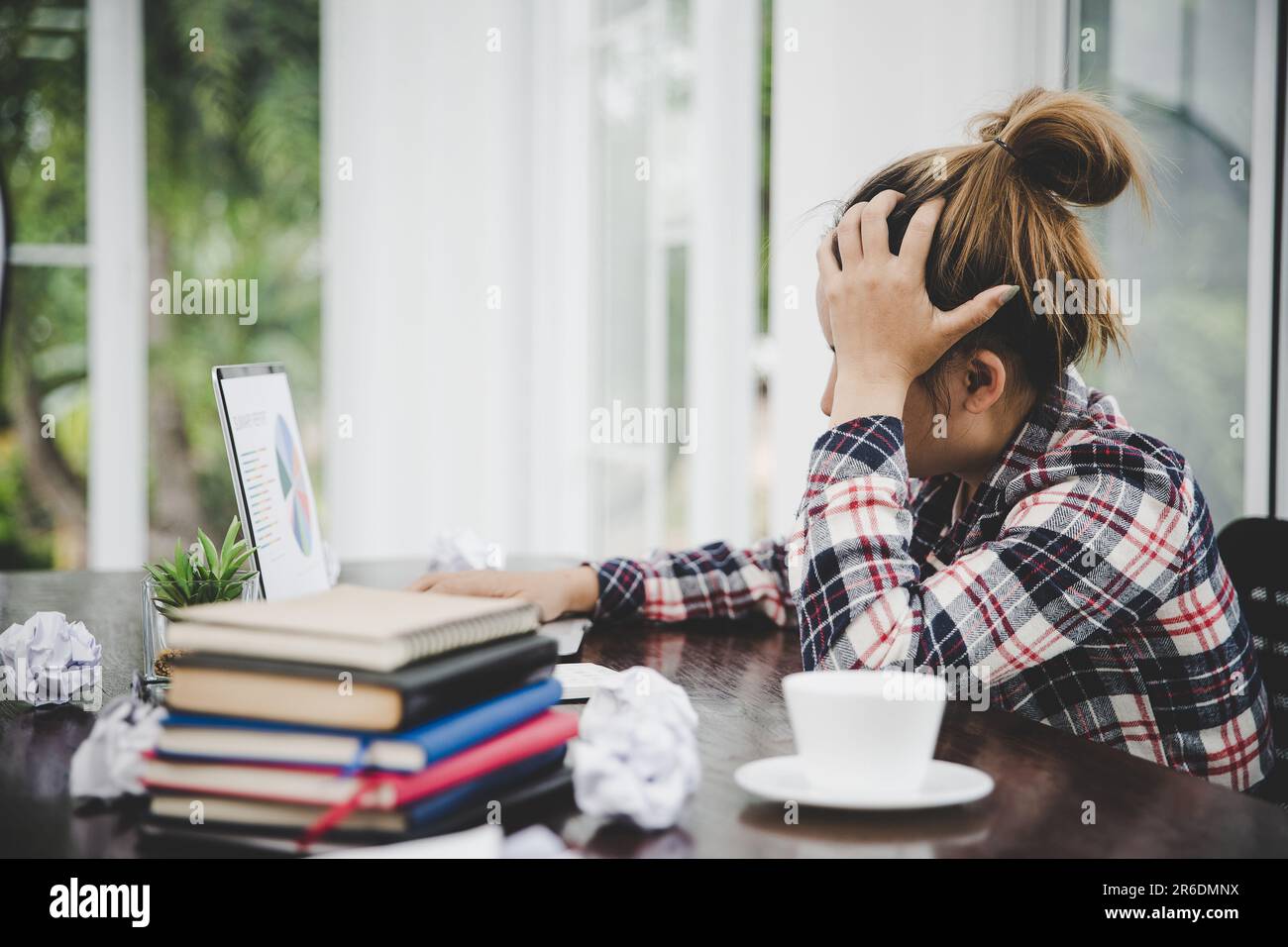 woman sitting down, his face unsettled. At the computer desk she has ...