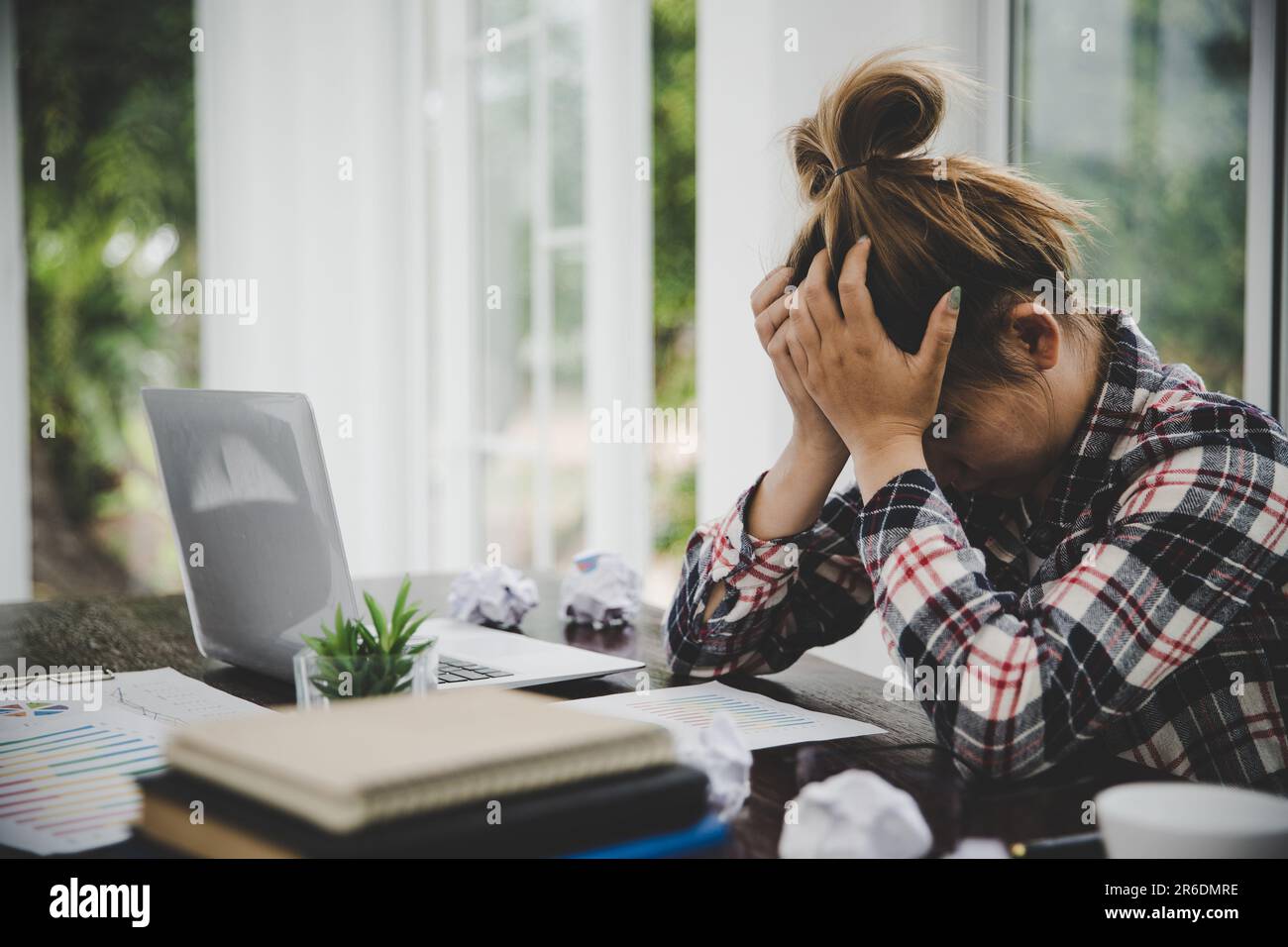 woman sitting down, his face unsettled. At the computer desk she has ...