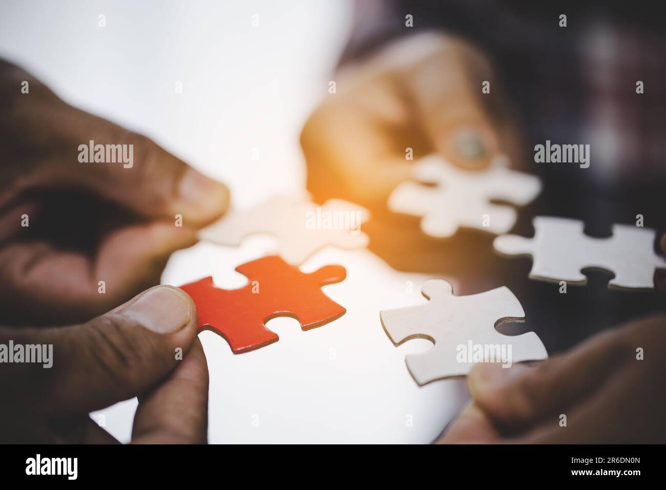 Hands holding piece of blank jigsaw puzzle for teamwork workplace ...