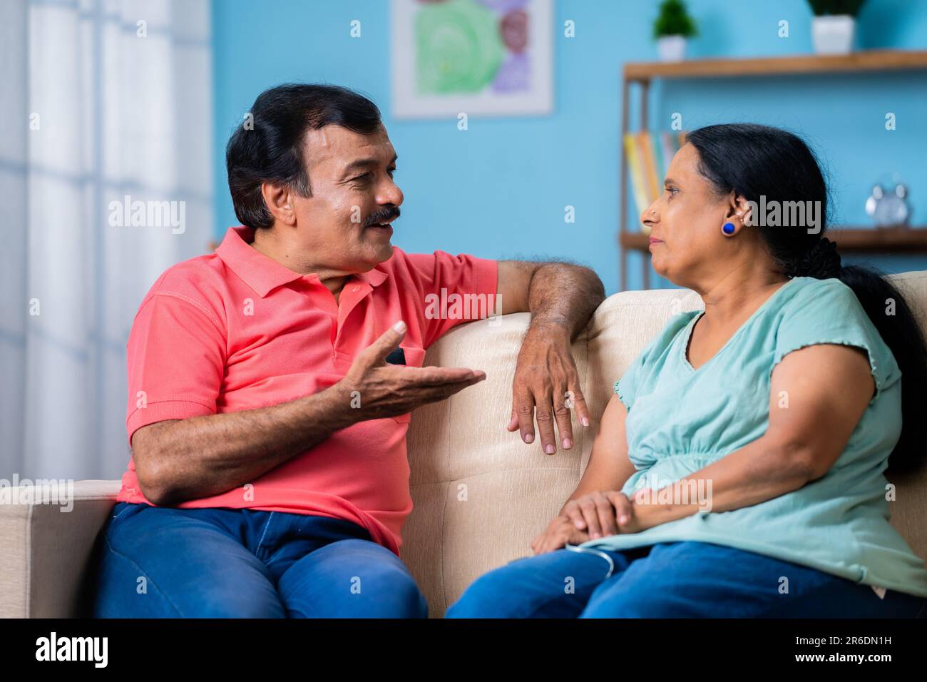 happy Indian senior couple discussing by talking each other while ...