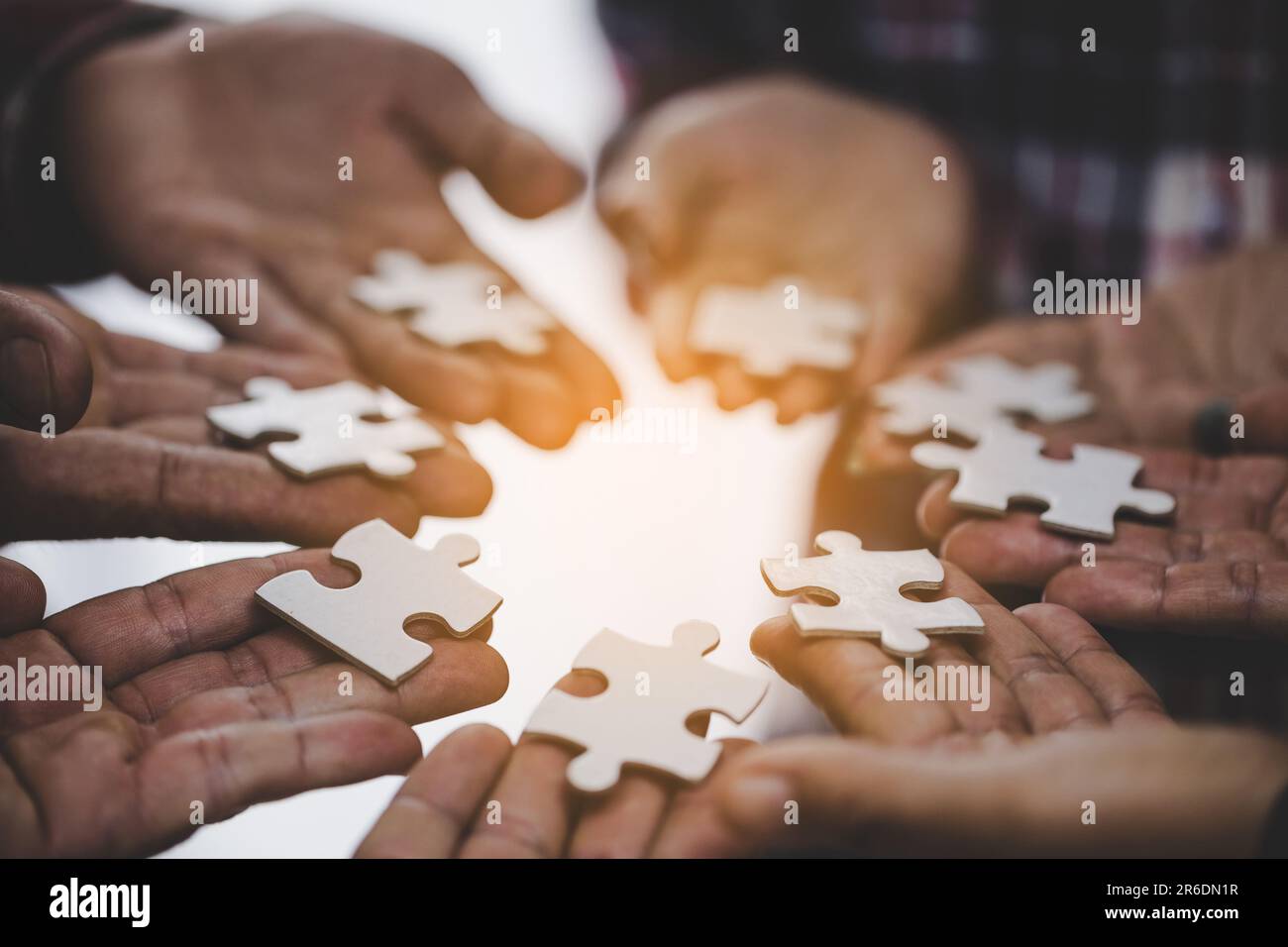 Hands holding piece of blank jigsaw puzzle for teamwork workplace ...