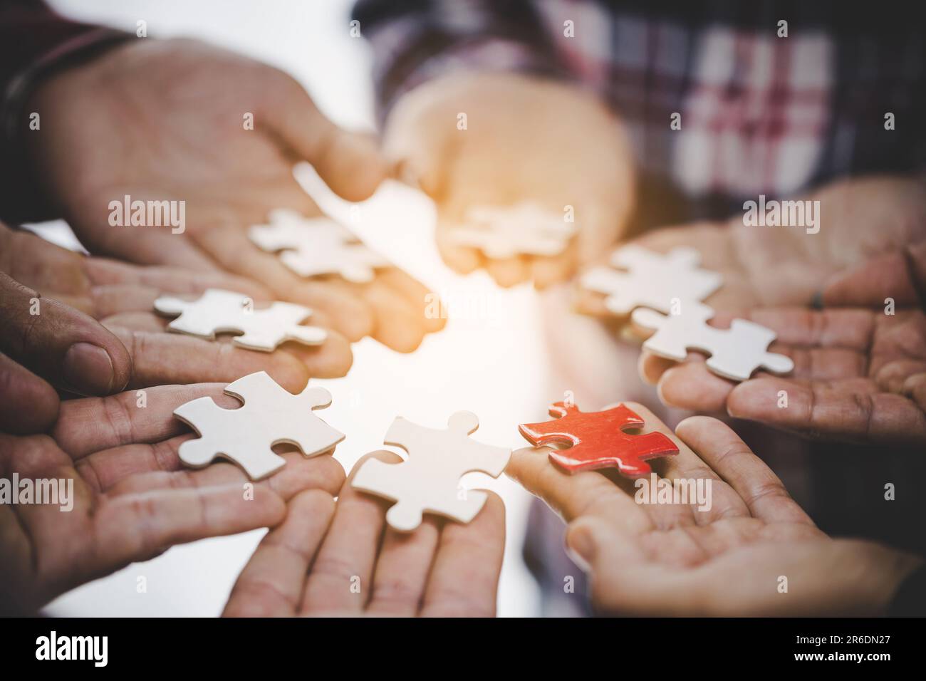 Hands holding piece of blank jigsaw puzzle for teamwork workplace ...