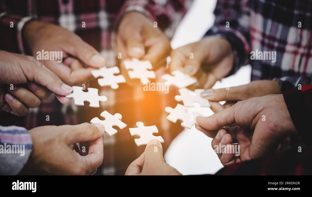 Hands holding piece of blank jigsaw puzzle for teamwork workplace ...