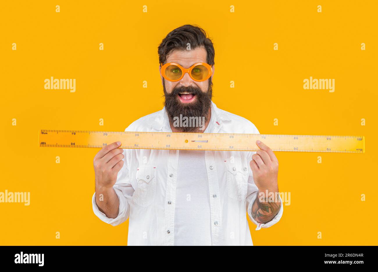 happy man hold geometry ruler isolated on yellow. man hold geometry ...
