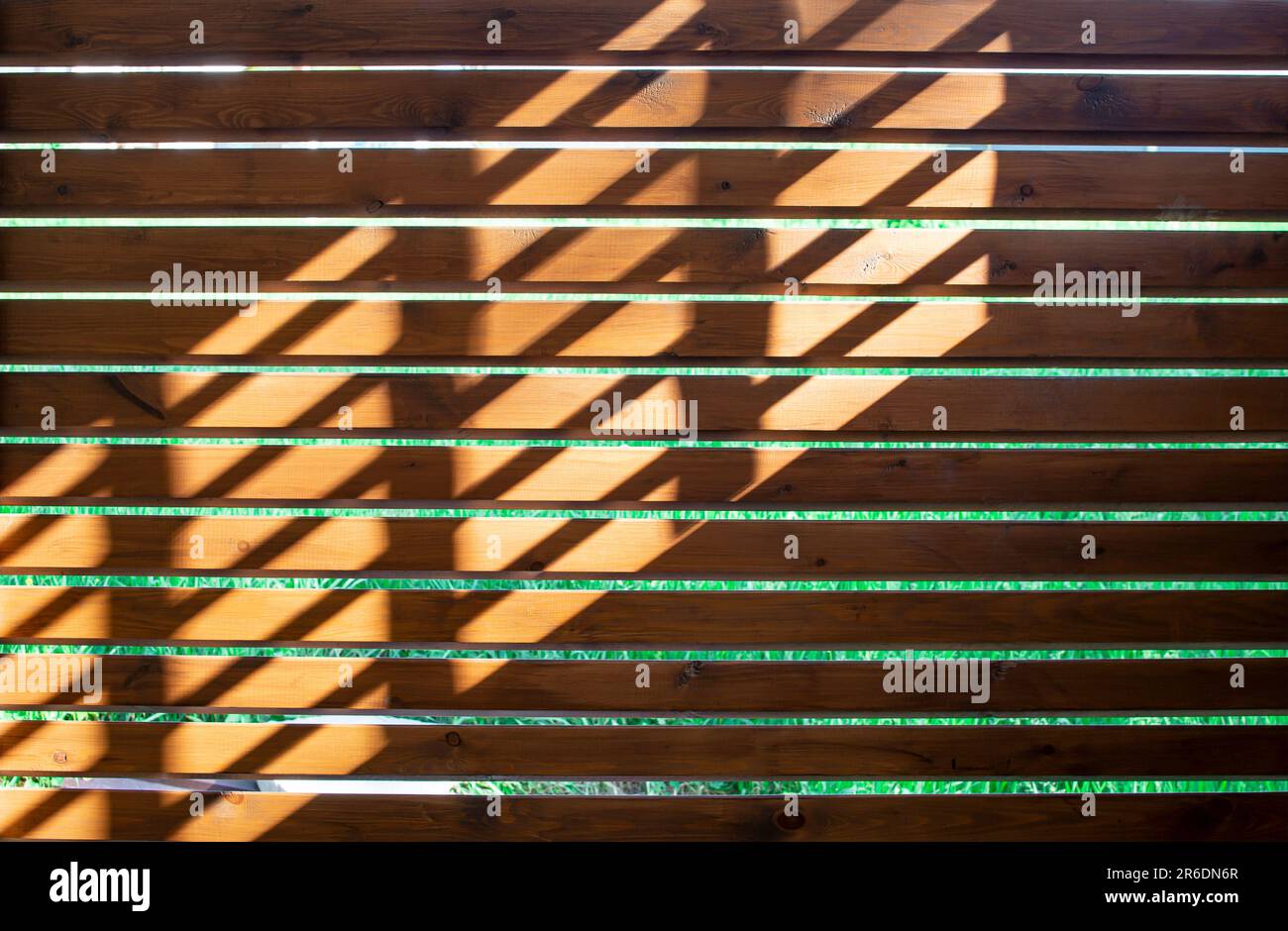 Horizontal wooden boards with diagonal sunlight pattern, abstract ...