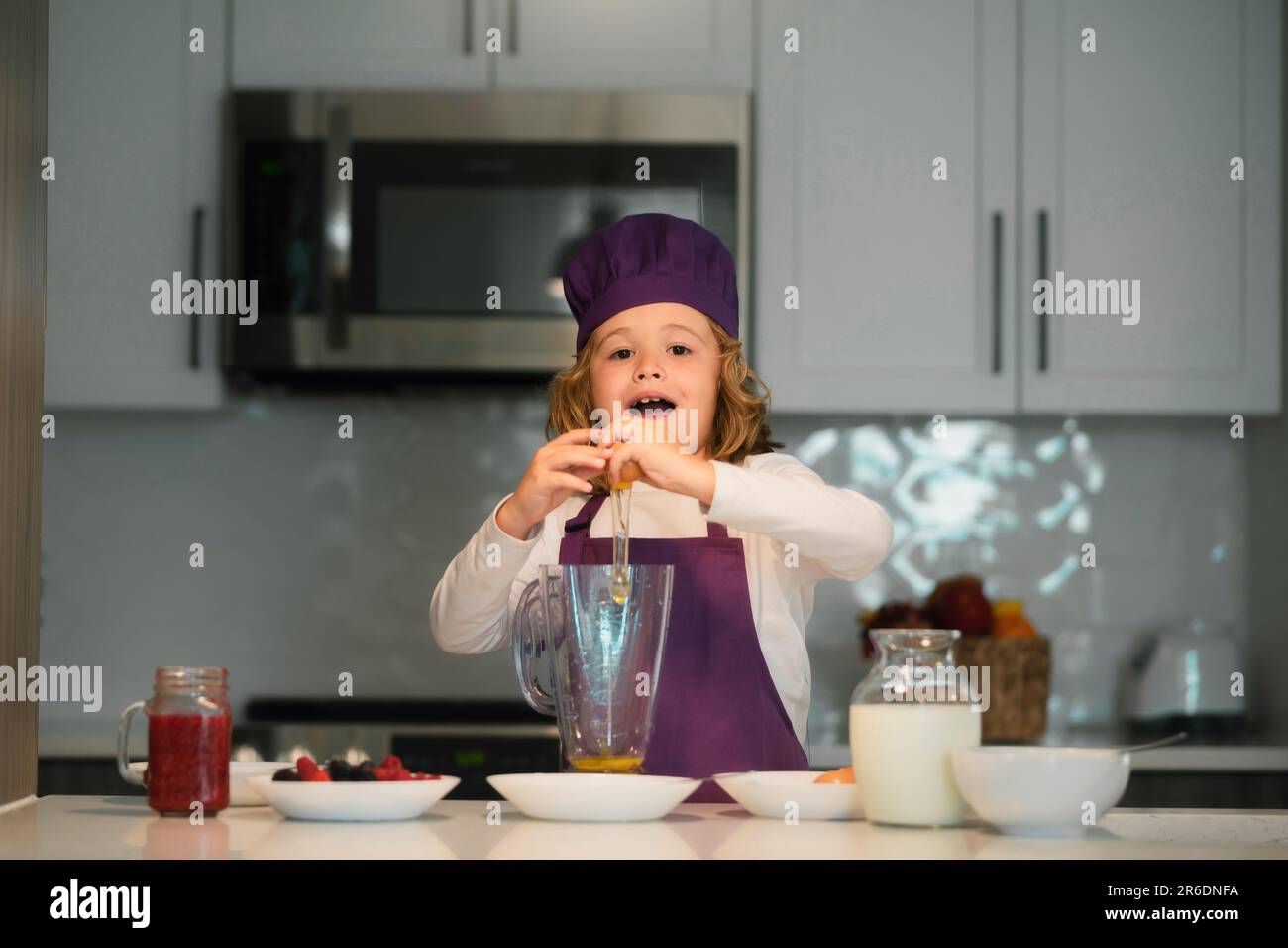 Cooking in kitchen. Chef cook child having fun preparing a cake in ...