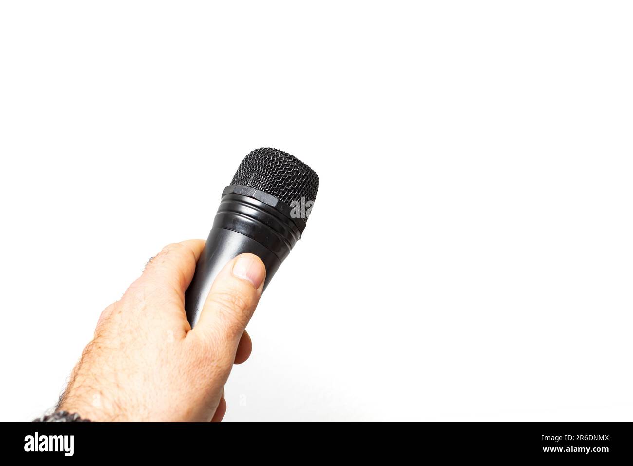 male hand holding a black microphone, isolated on white background ...