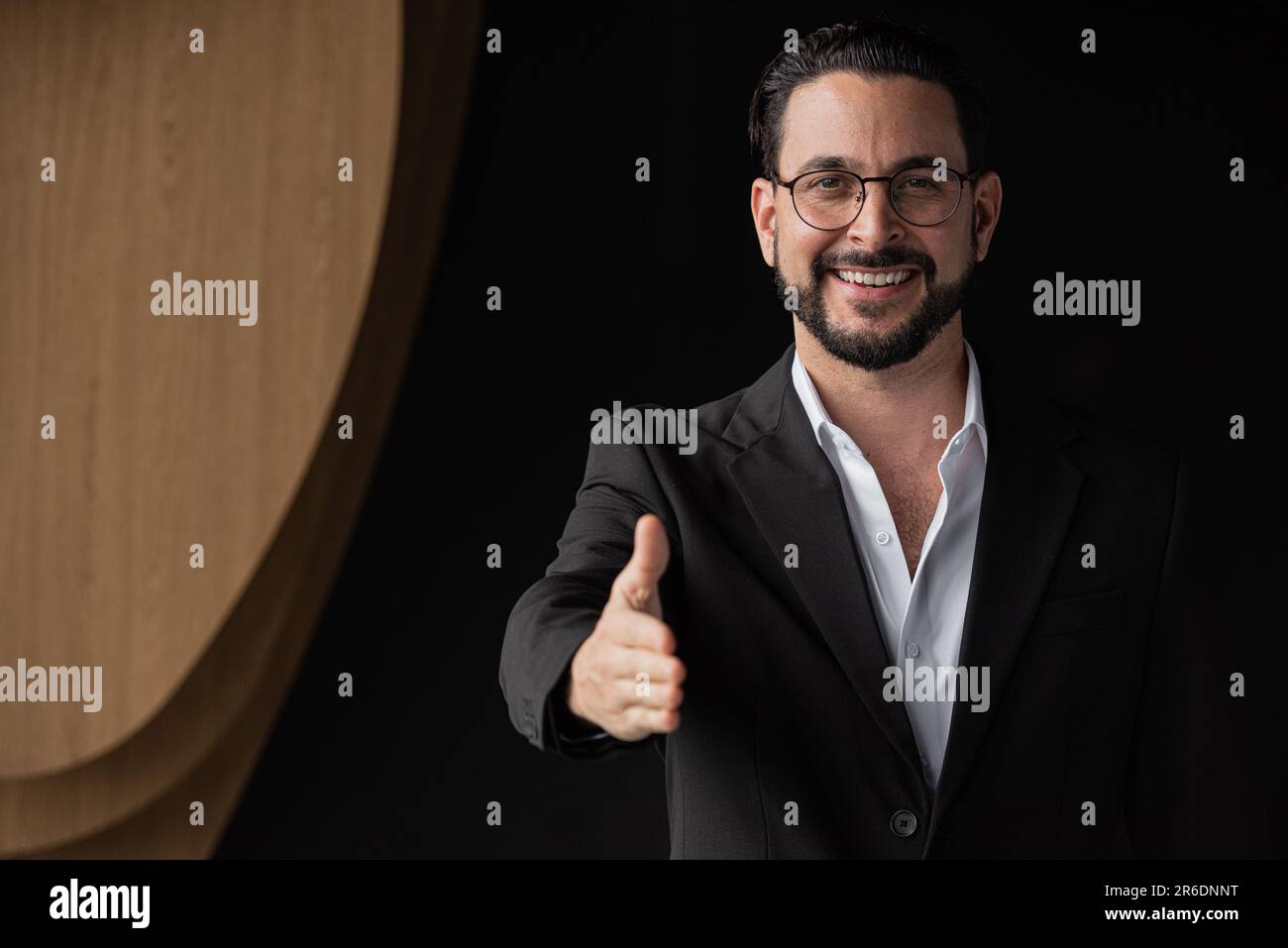 Portrait confident hispanic businessman shaking hi-res stock photography and images - Alamy