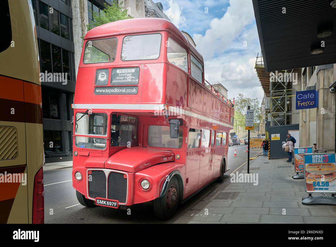 Old fashioned red, double decker, open-top bus parked on Tothill Street ...
