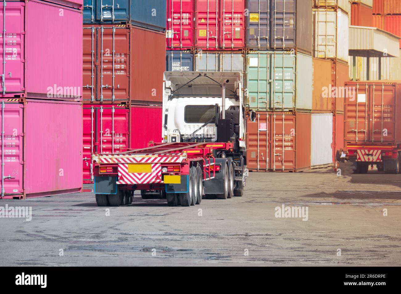 Trucks in the view of the container industry Stock Photo - Alamy