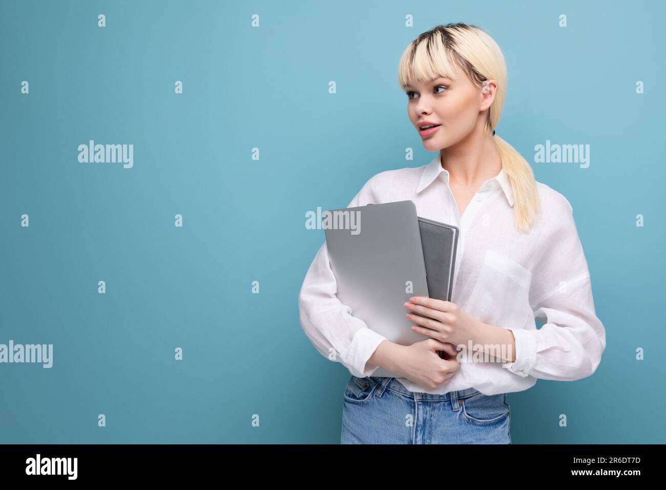 young blond caucasian woman with a short haircut dressed in a white ...