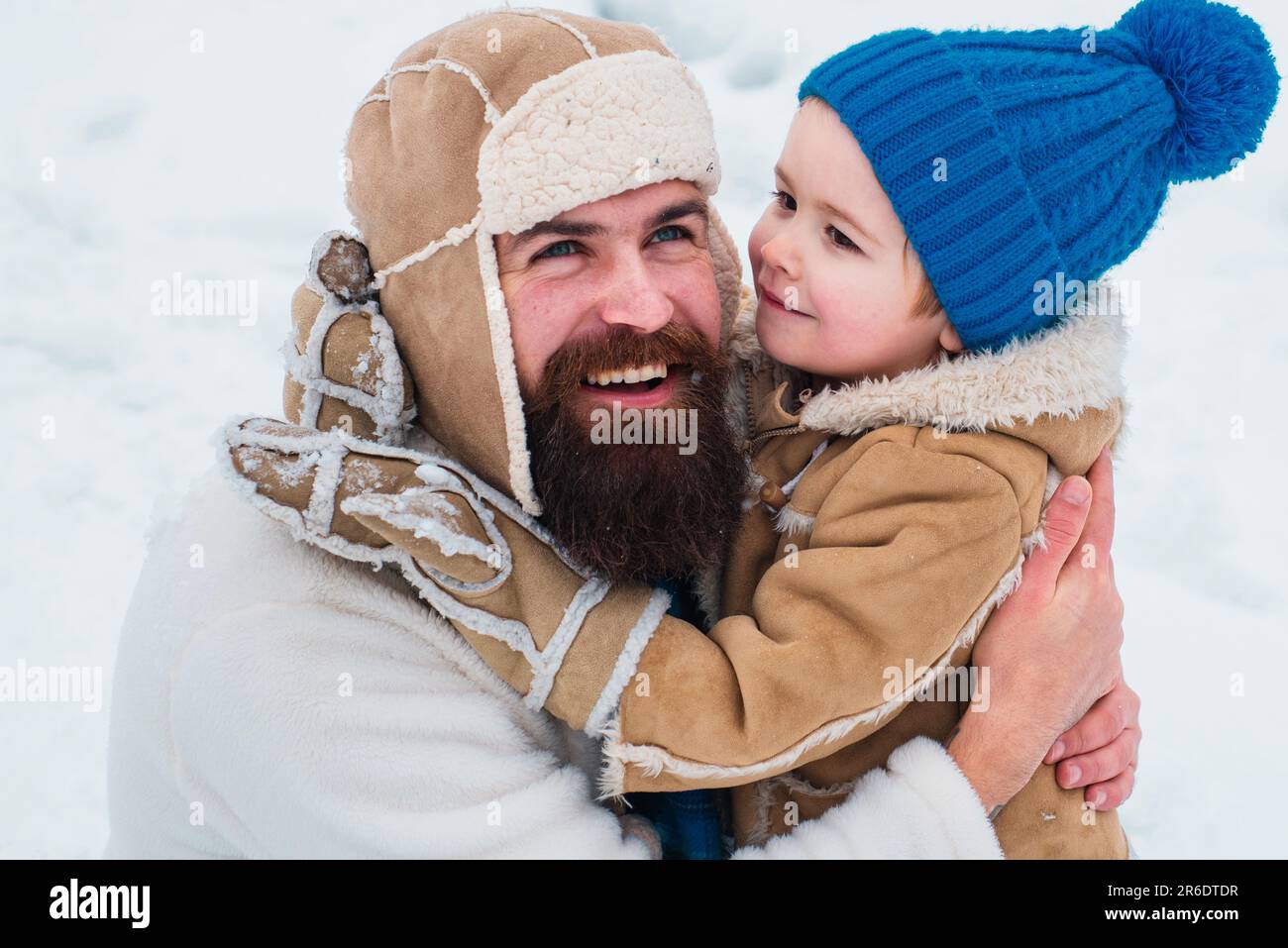Daddy and boy smiling and hugging. Happy family son hugs his dad on ...