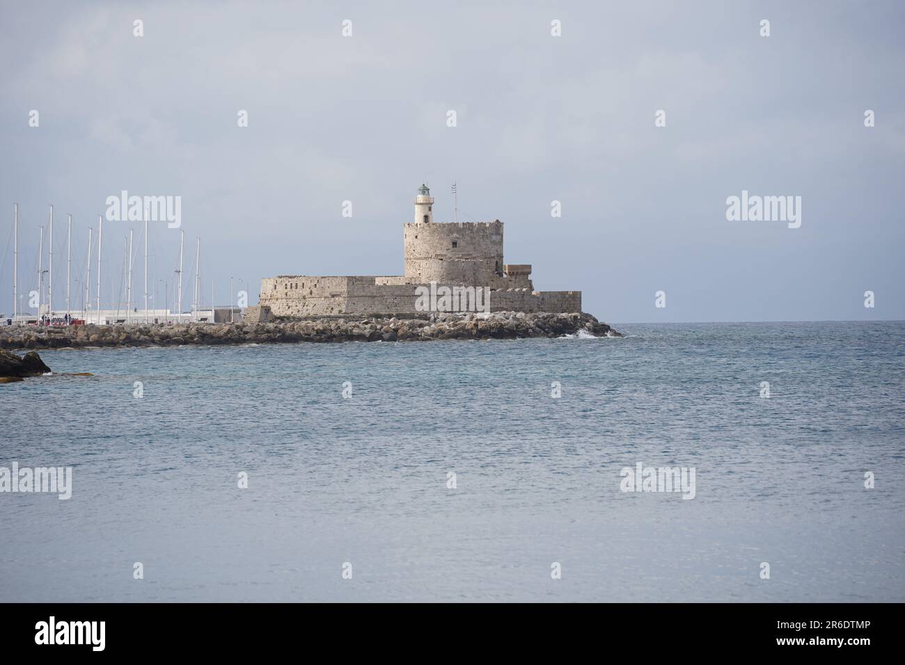 The Fort of St Nicholas and Lighthouse in Mandaki Harbor at Rhodes town ...