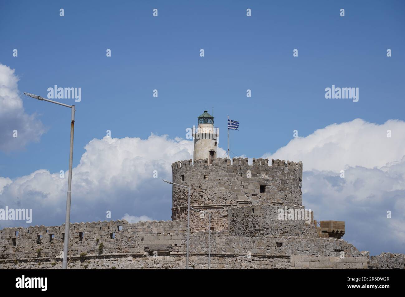 The Fort of St Nicholas and Lighthouse in Mandaki Harbor at Rhodes town ...