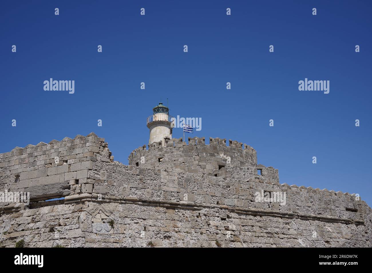 The Fort of St Nicholas and Lighthouse in Mandaki Harbor at Rhodes town ...
