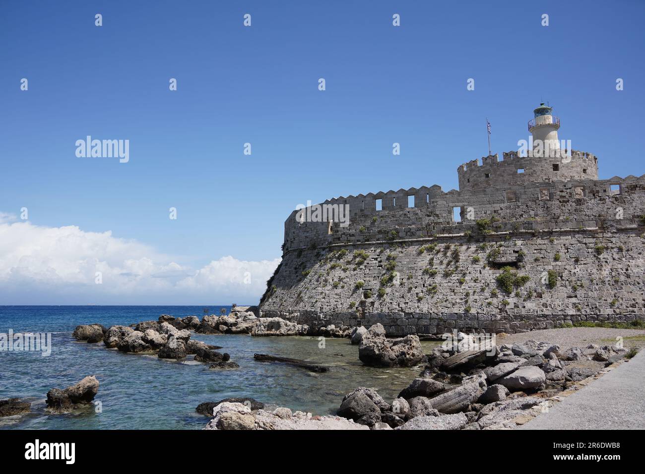 The Fort of St Nicholas and Lighthouse in Mandaki Harbor at Rhodes town ...