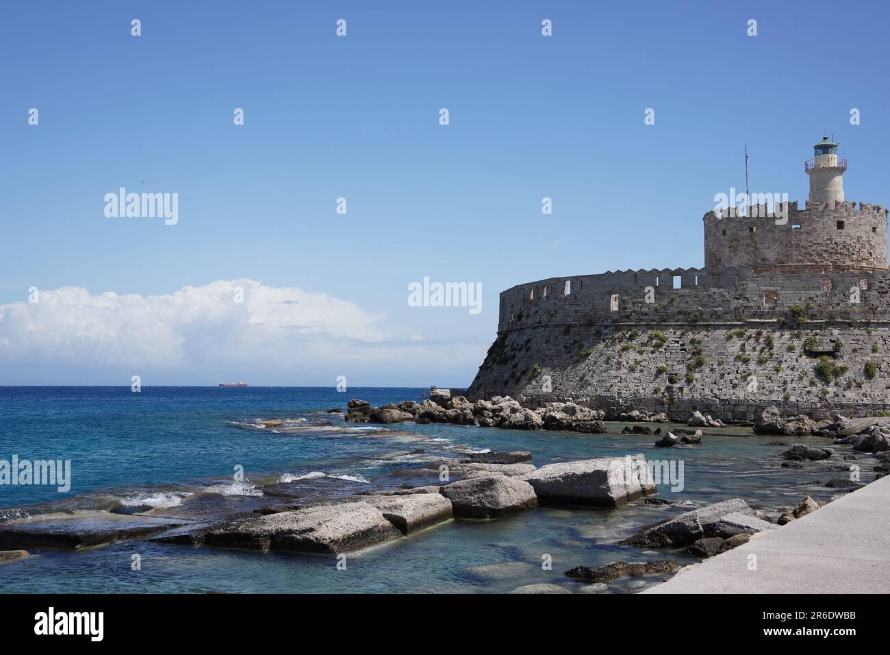 The Fort of St Nicholas and Lighthouse in Mandaki Harbor at Rhodes town ...