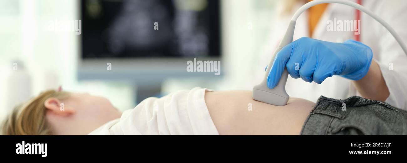 Doctor conducting abdominal ultrasound examination of internal organs ...