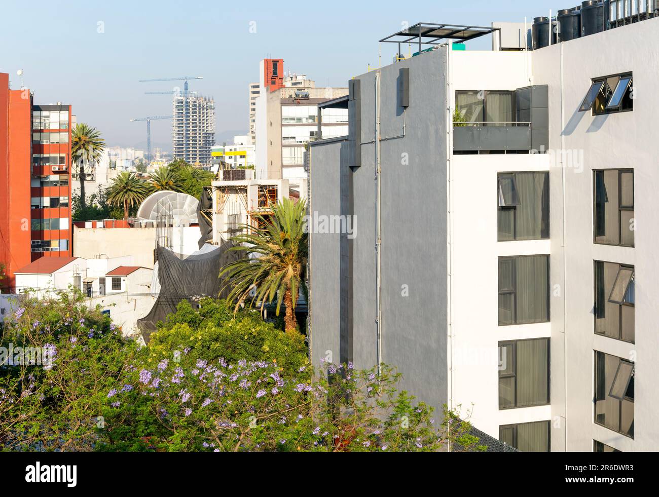 View over buildings to cranes and construction work on high high-rise ...