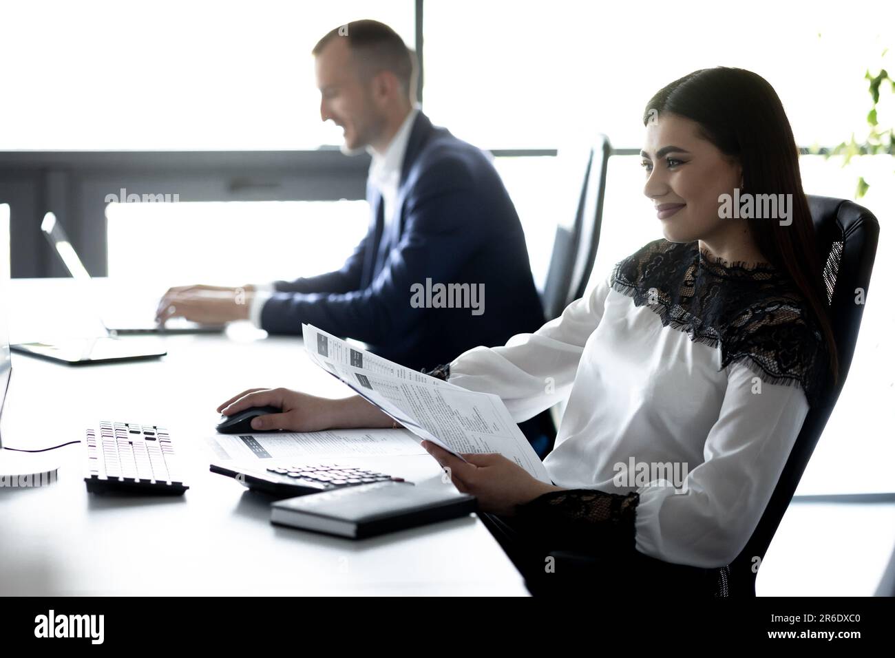 Two corporate professionals working diligently together at their office ...