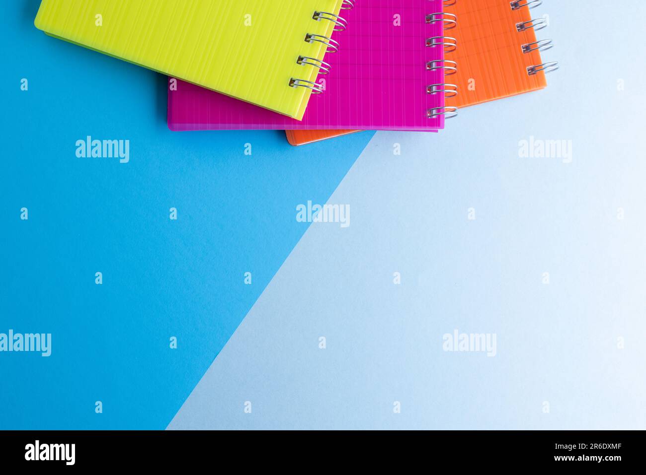 Three notebooks with binding and copy space on blue background. Reading ...