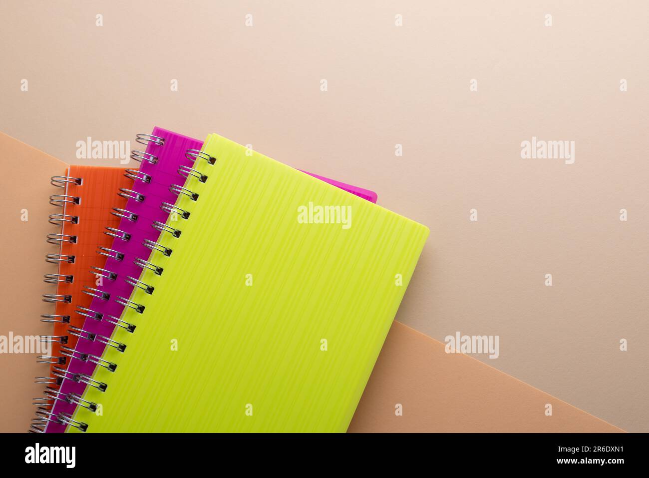 Flat lay of three notebooks with binding with copy space on orange ...