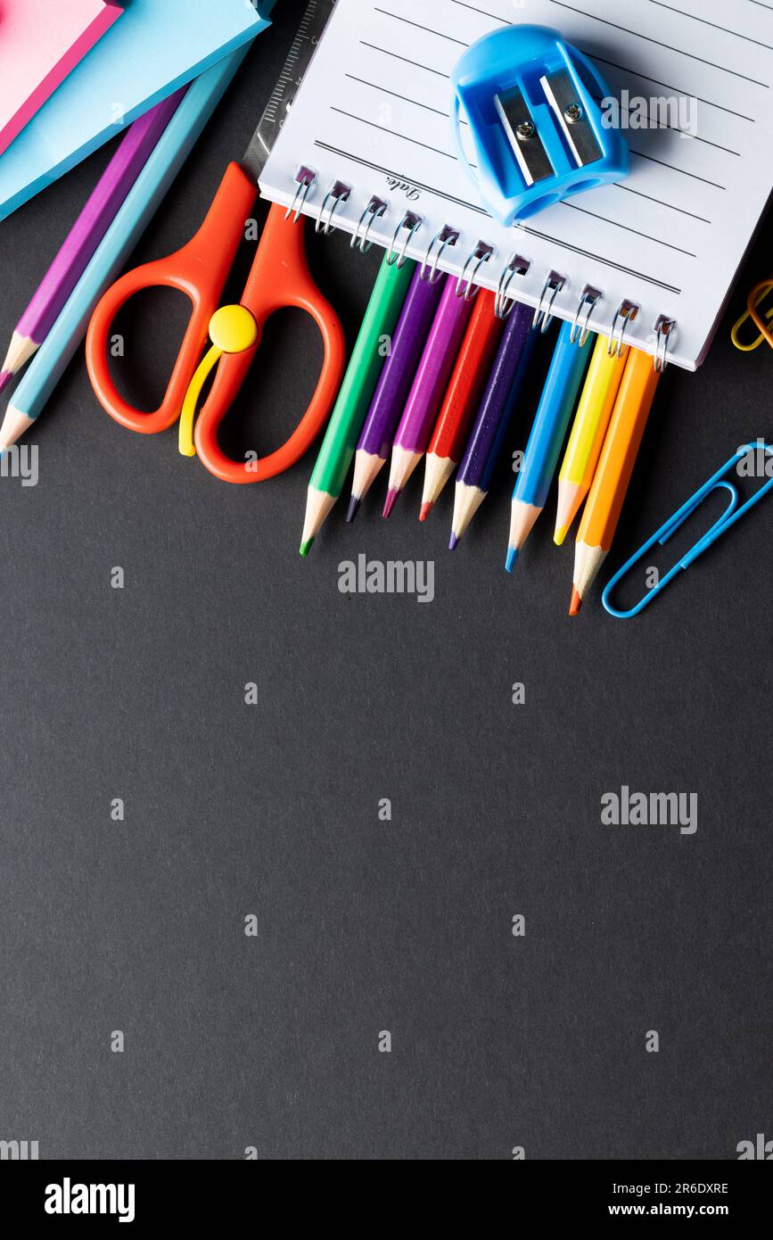Close up of coloured pencils and school materials with copy space on ...