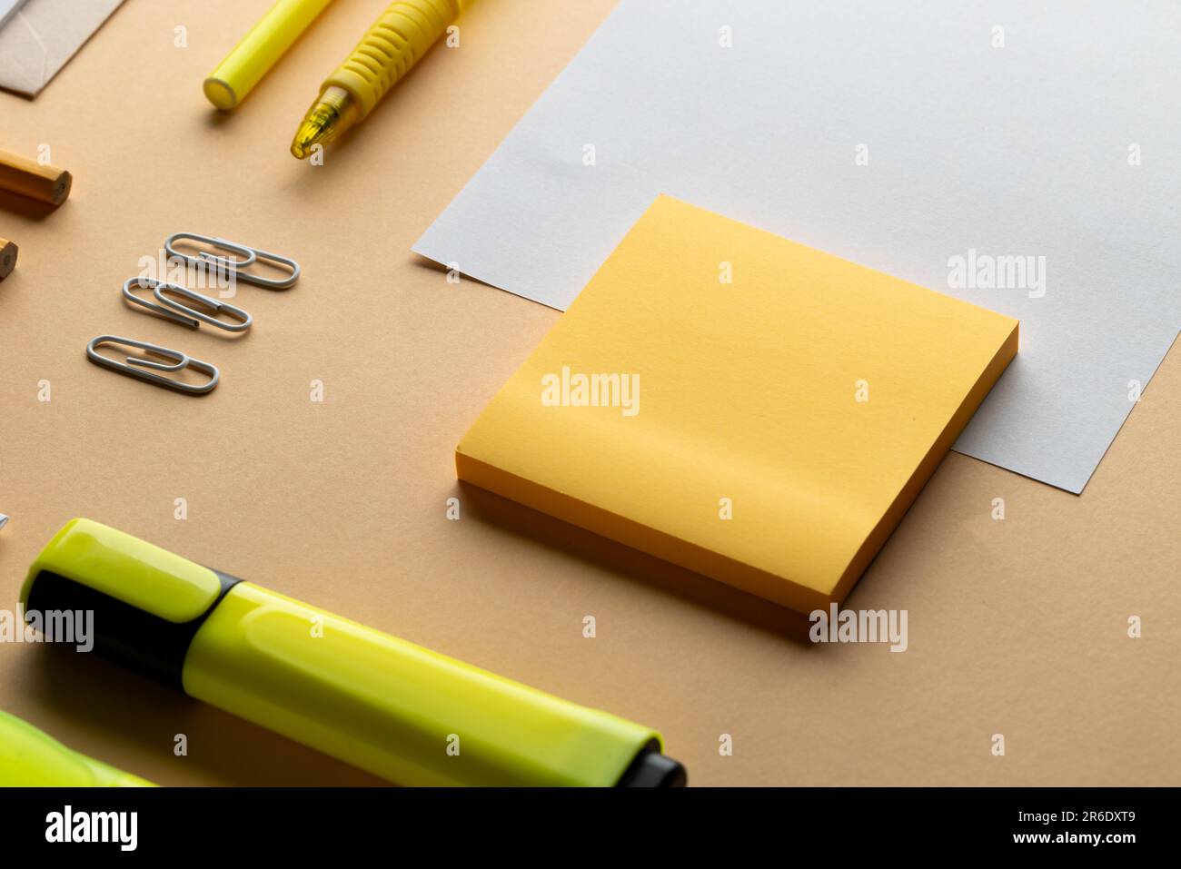 Flat lay of yellow notes, pen and highlighter and white paper with copy ...