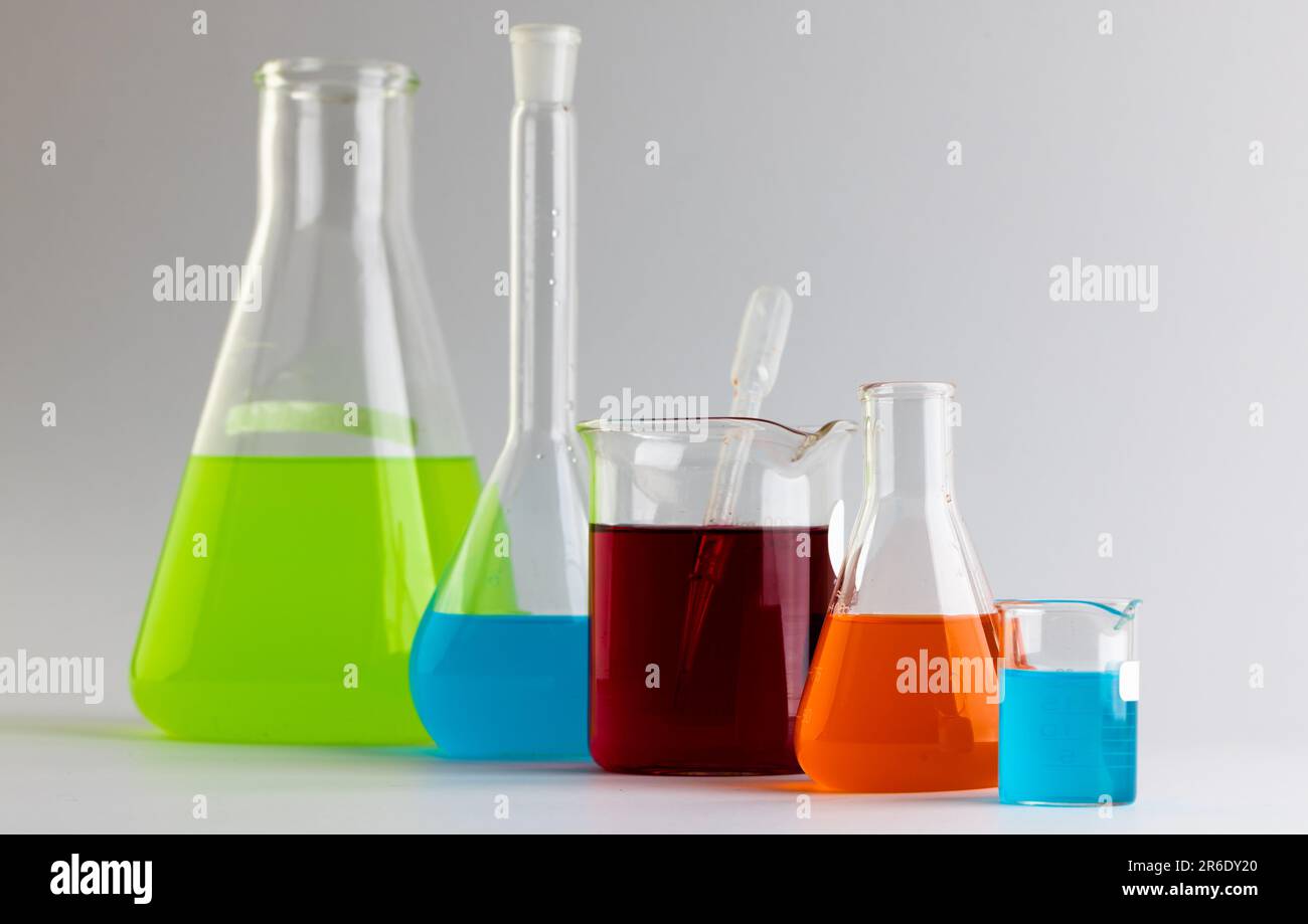 Close up of chemistry beakers and dishes with liquid and copy space on ...
