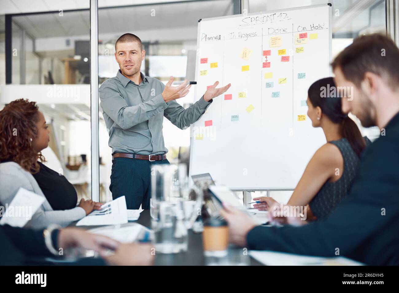 Data review, colleagues with chart and planning in a business meeting ...