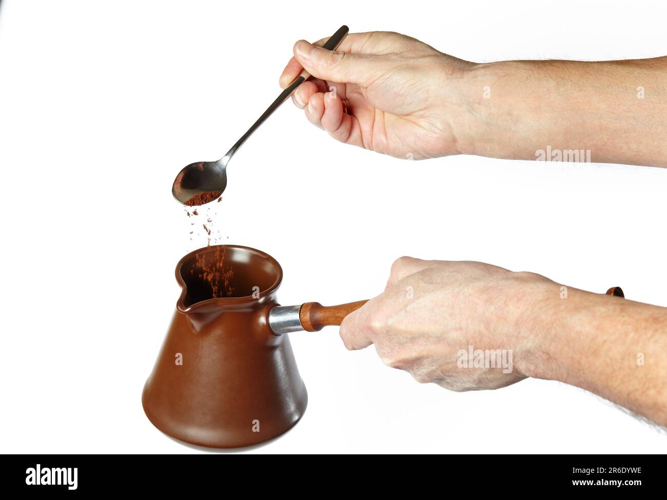 Men's hand holding spoon with coffee powder isolated white background ...