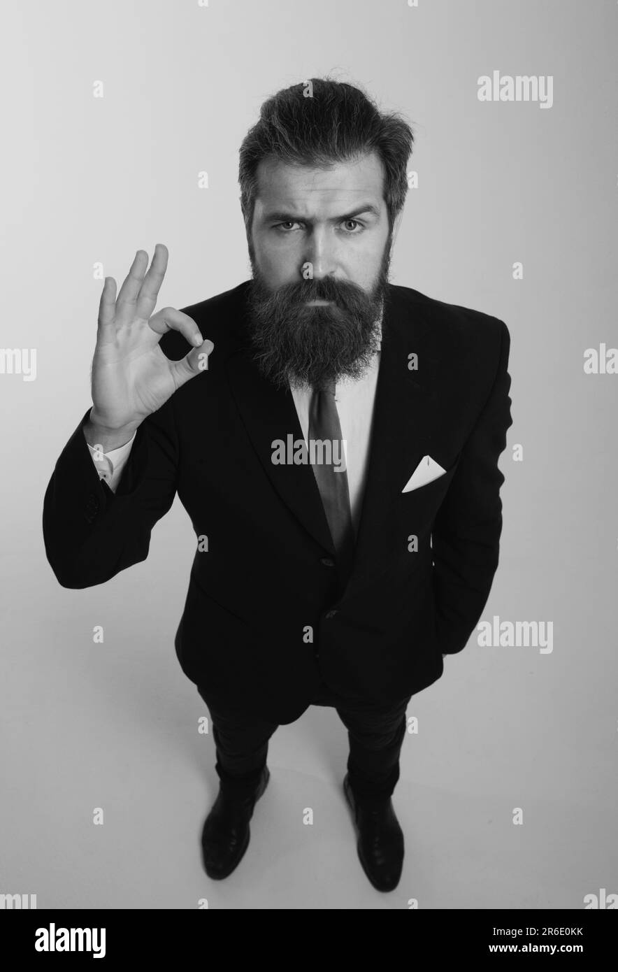 Businessman in suit. Business man in black suit smiling and showing ok ...